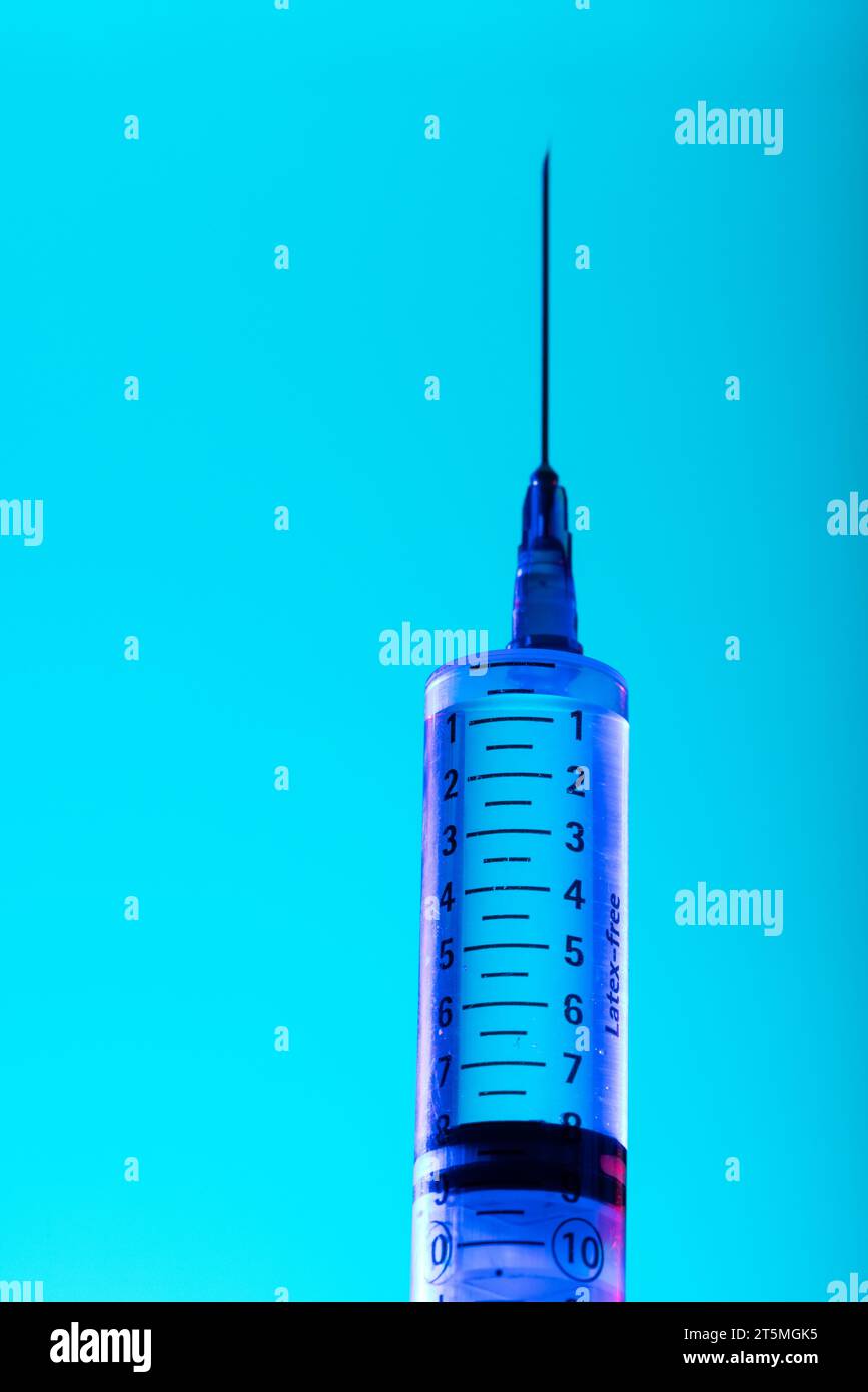 Vertical image of close up of syringe with needle and copy space on ...