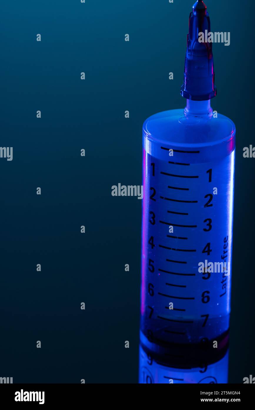 Vertical image of close up of syringe with needle and copy space on ...