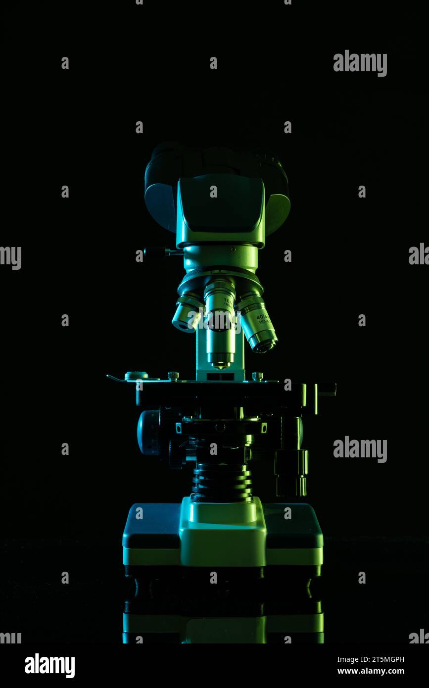 Vertical image of laboratory microscope and copy space on black ...