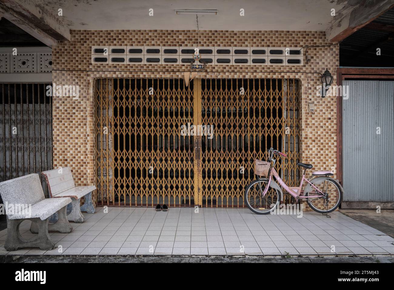 The old facade of a residential building in Thailand, the city of Takua ...