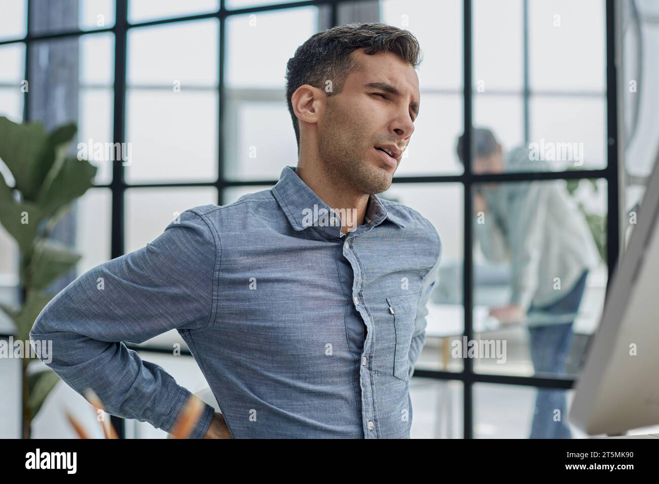 Male getting up and stretching to straighten his back Stock Photo - Alamy