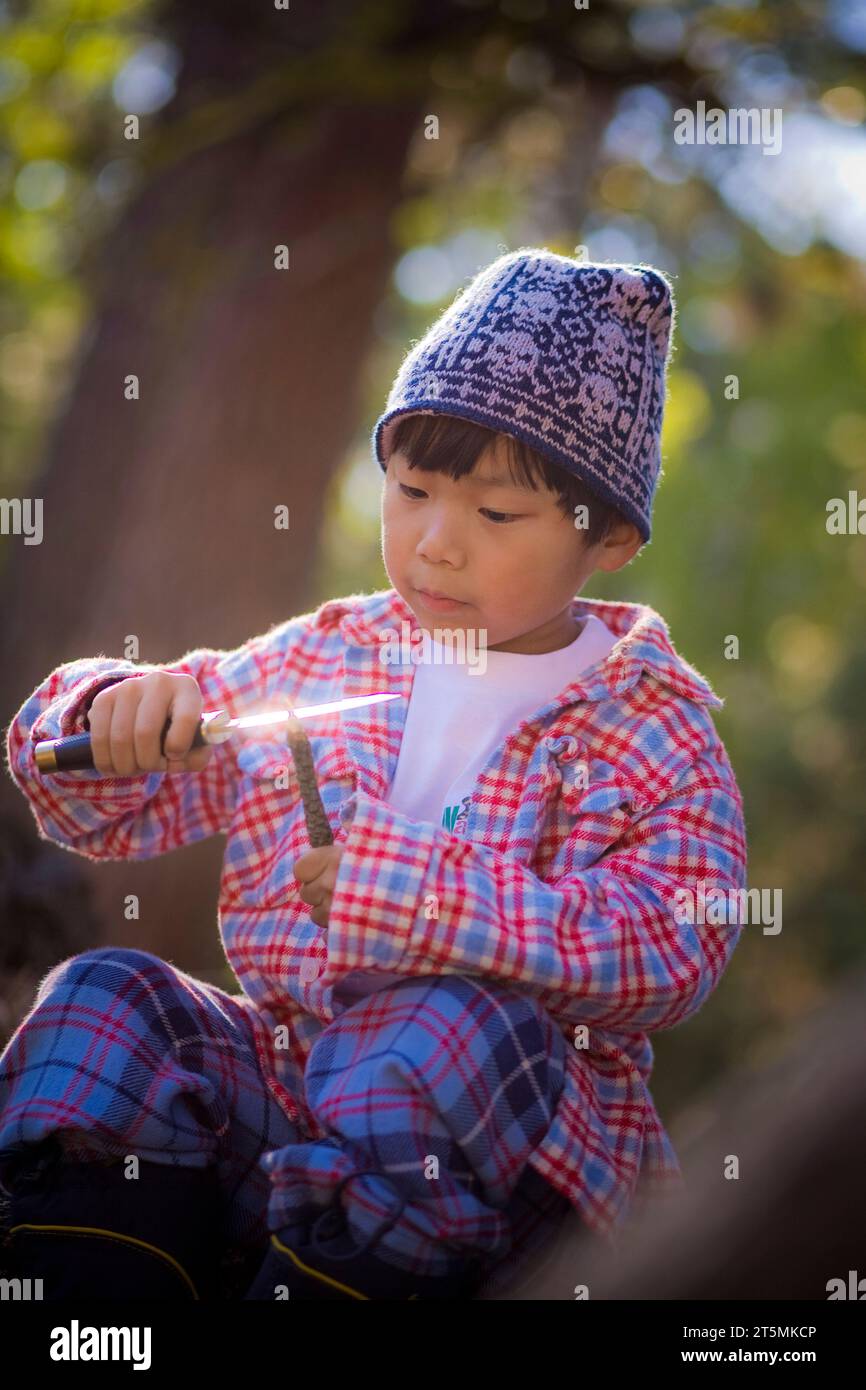 A boy whittles with a hunting knife Stock Photo - Alamy