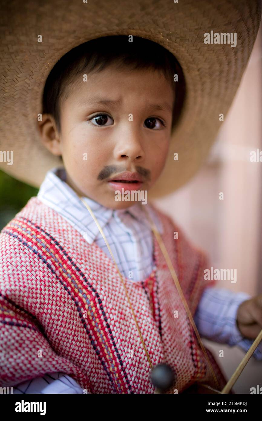 A young mexican boy, wearing a sombrero, gets ready to perform at a ...
