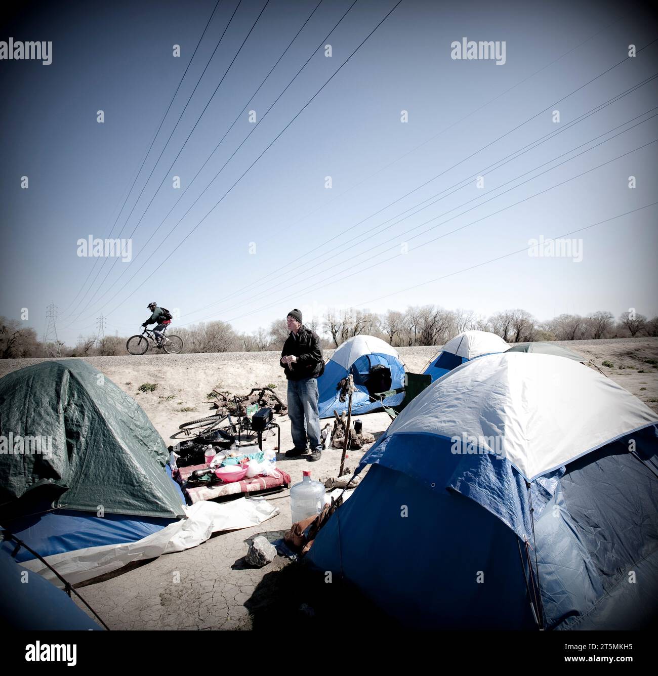 Man standing in a homeless tent city Stock Photo - Alamy