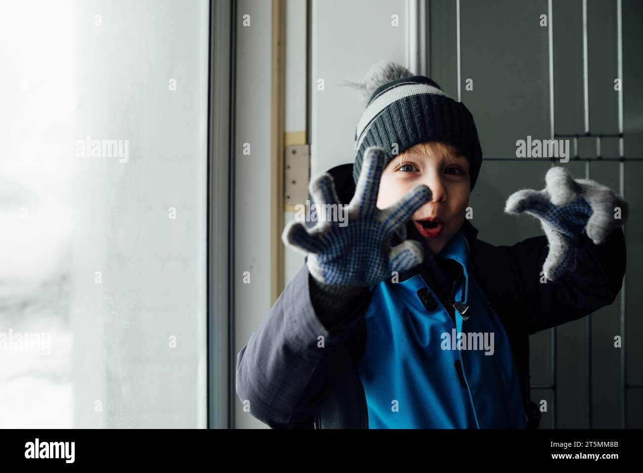 Little boy holds hands up like claws while making silly face in Stock ...