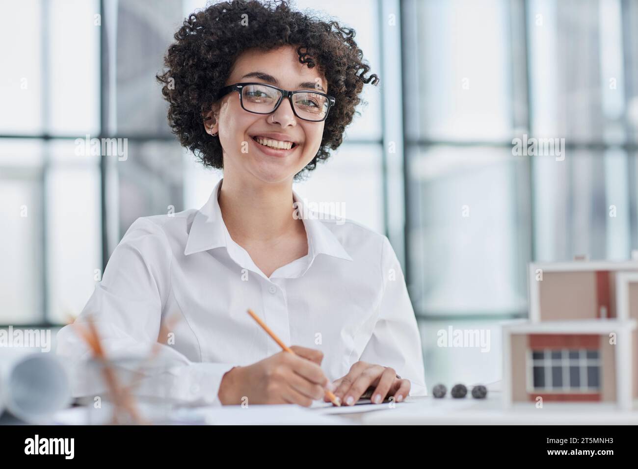 female architect designer examines house layout Stock Photo - Alamy