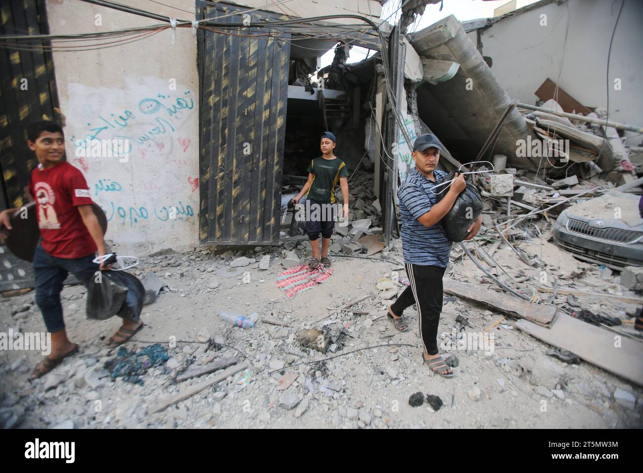 People search through buildings, destroyed during Israeli air raids on ...
