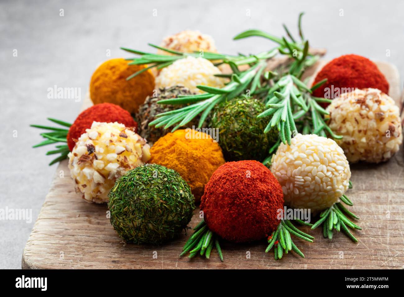 Cheese balls covered with various spices and nuts decorated with ...