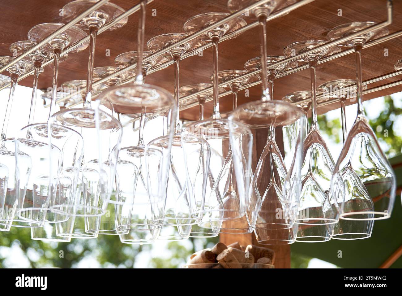 Close-up of an upside-down hanging wine glass. Outdoor bar counter ...