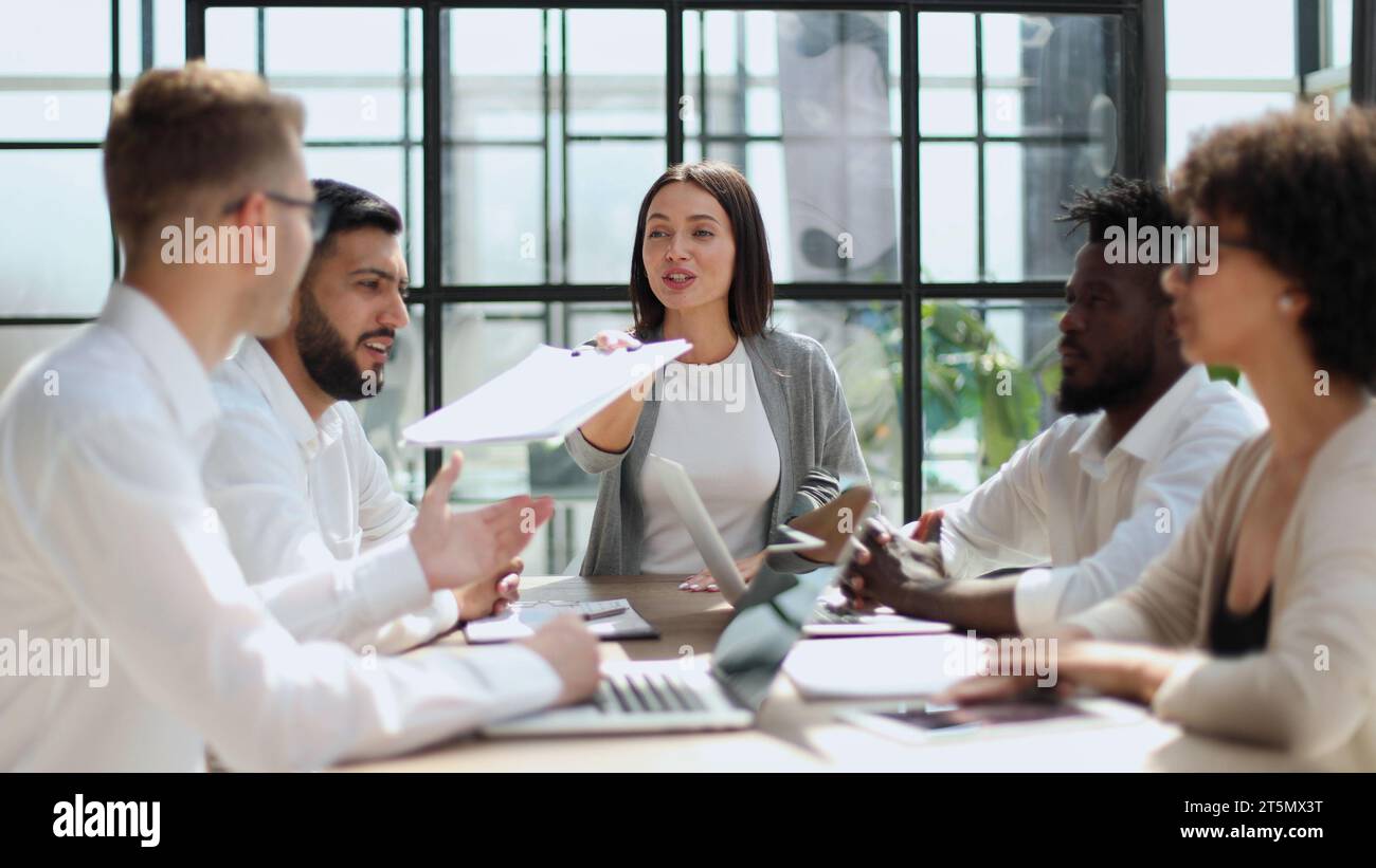 Employees working at computer together, discussing content Stock Photo ...