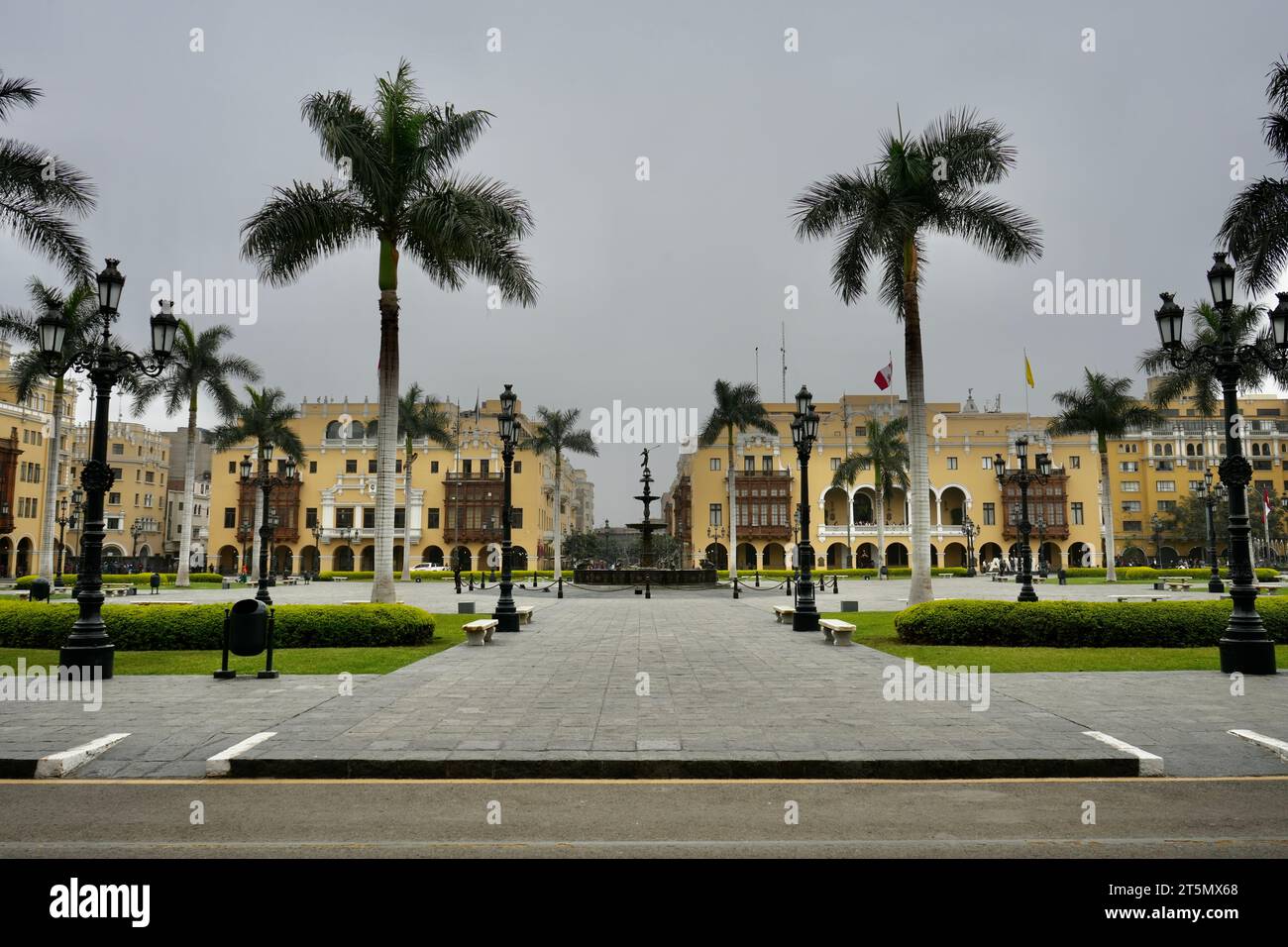 Lima Main Square with historic yellow buildings, palm trees and ...