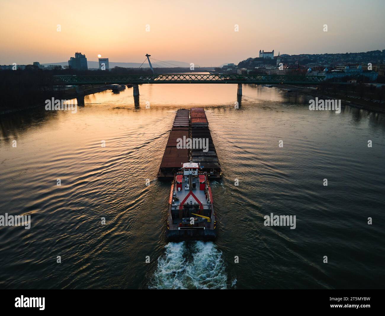 Aerial view of a cargo ship sailing on the Danube through Bratislava ...