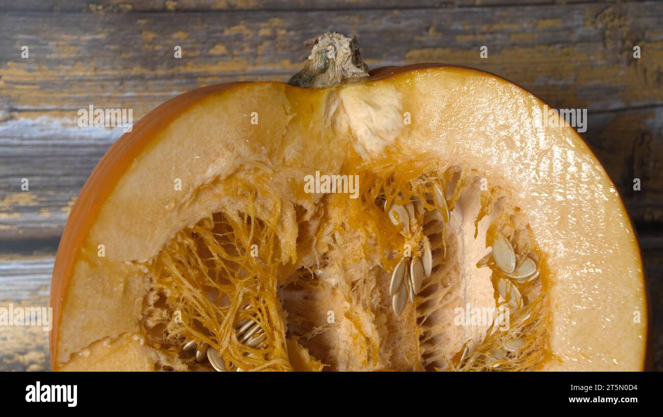 Inside and close up of large orange pumpkin showing seed and pith Stock ...