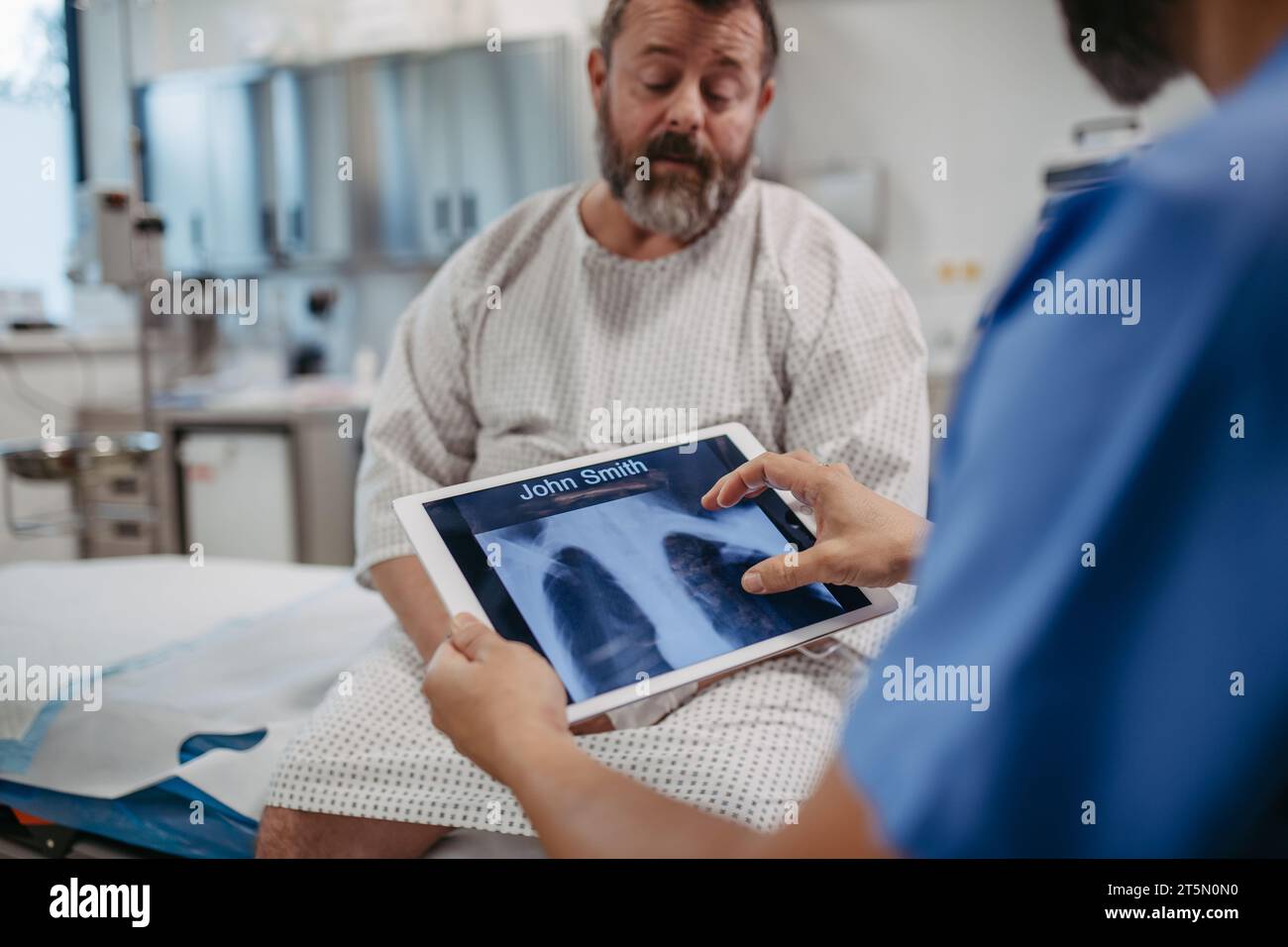Doctor showing overweight patient chest x-ray, discussing test result ...