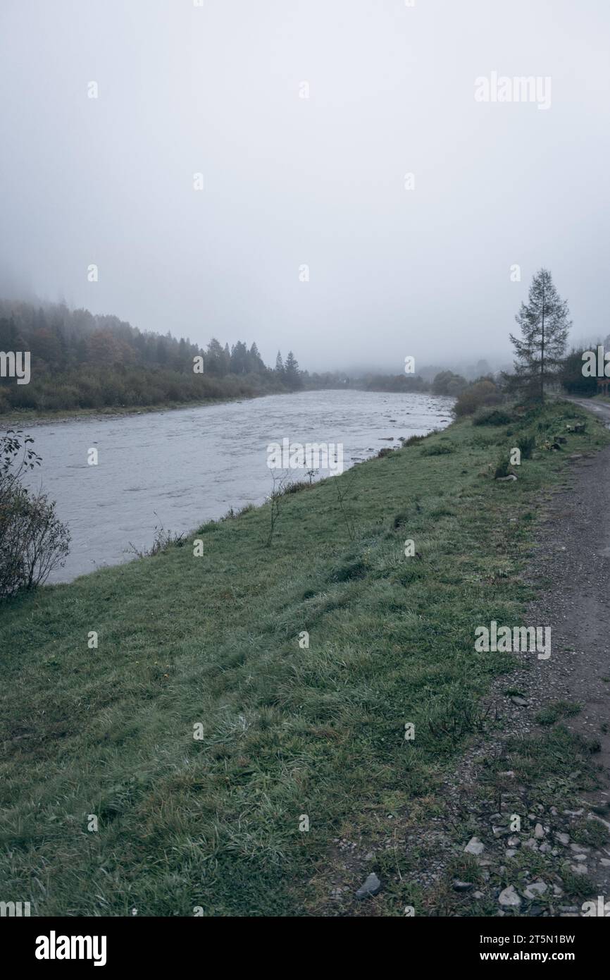 Fog on the river in autumn mountains. Frosty morning in mountains at ...