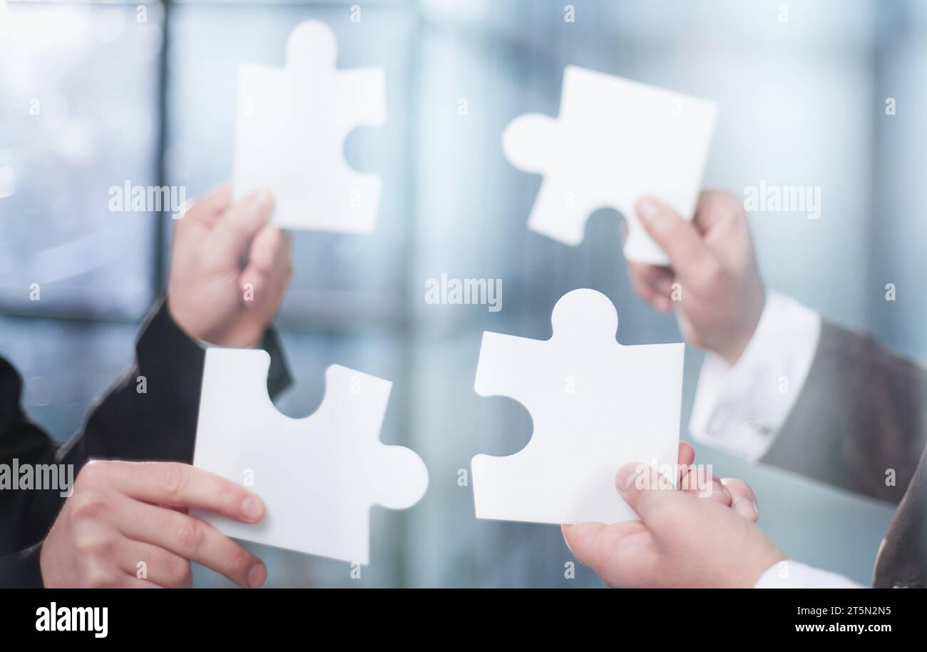 Working together to put things together. two unrecognizable ...