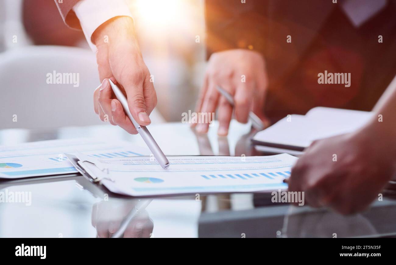 Business people showing graphs meeting hi-res stock photography and ...