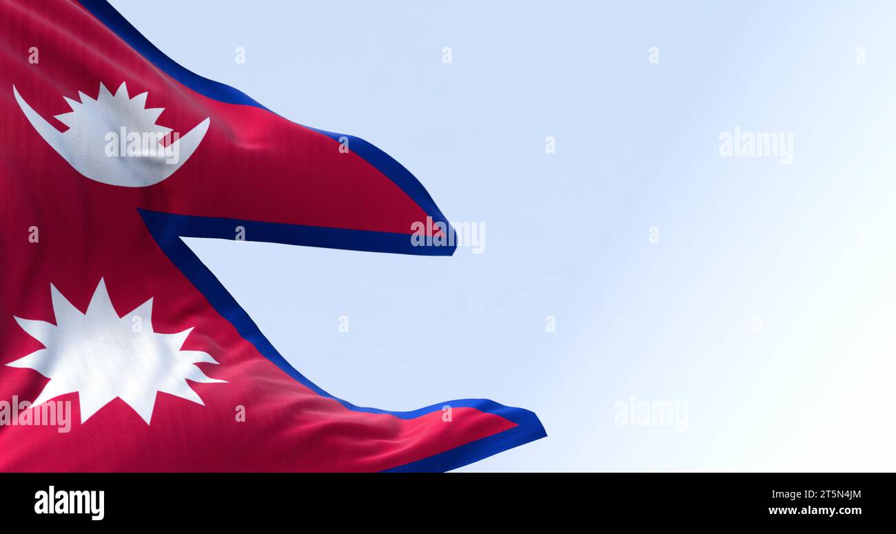 Close-up of Nepal National flag waving in the wind on a clear day. The ...
