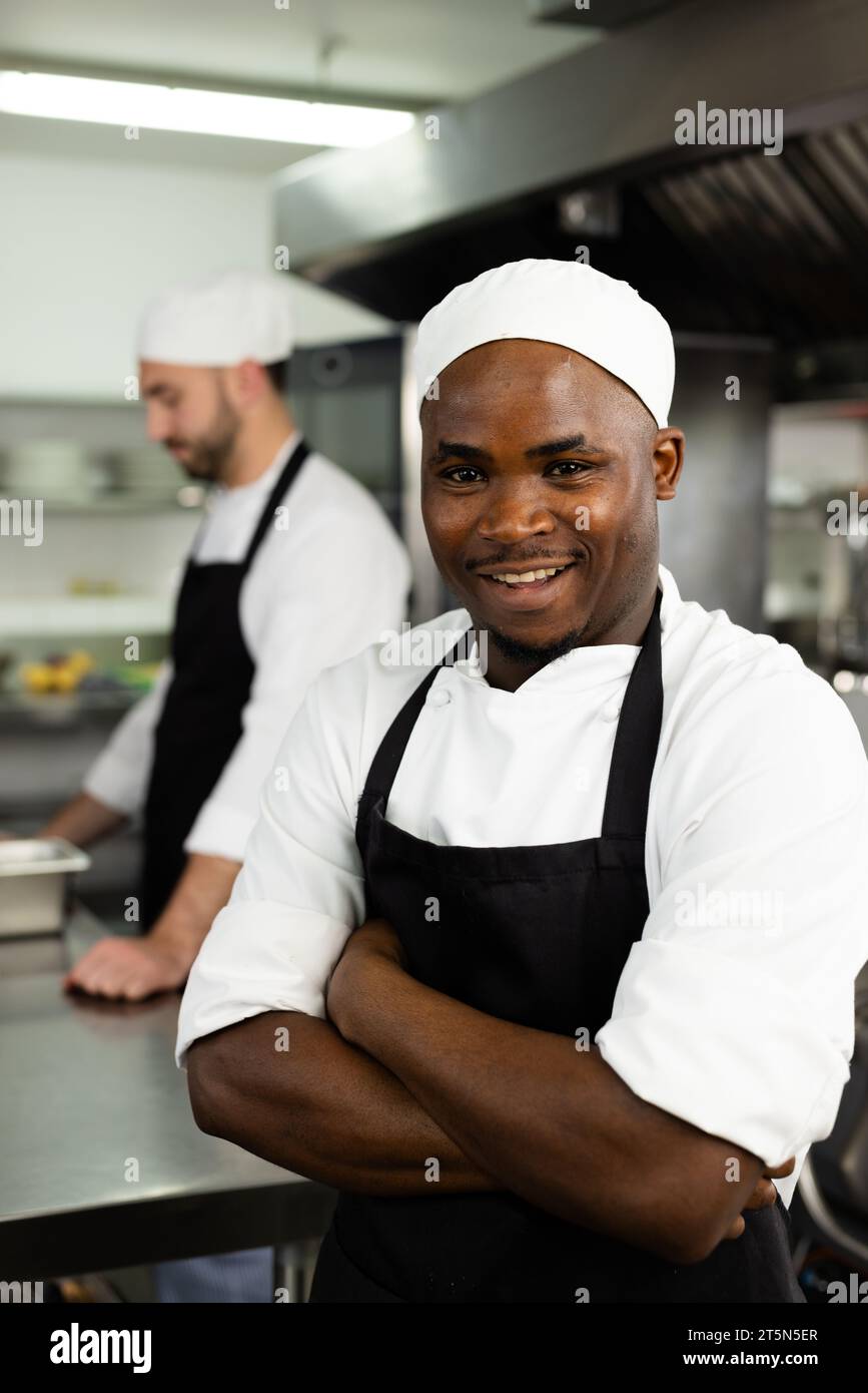 Portrait of happy african american male chef standing with arms crossed ...