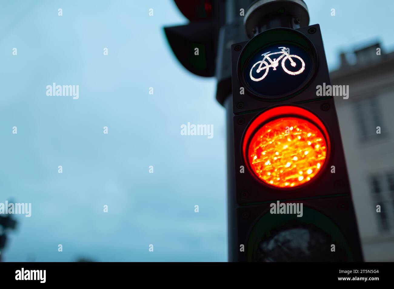 Photograph of a red traffic light for bicycles, seen from close up in a ...