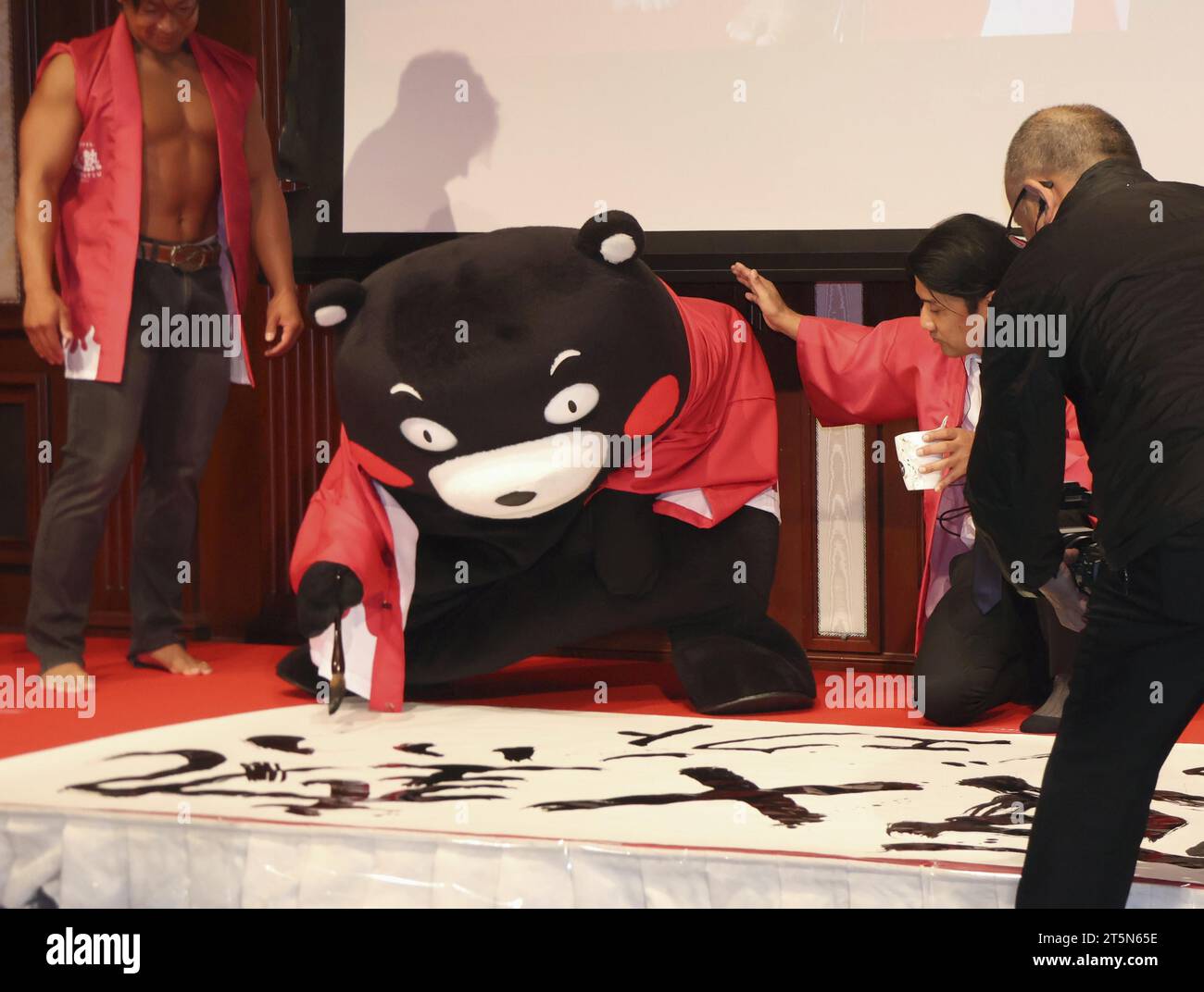 Kumamon, the official mascot of Japan's Kumamoto Prefecture, writes in ...