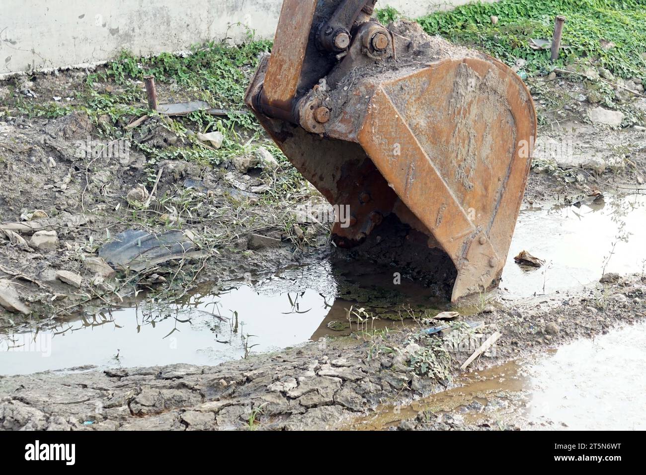 Bulldozer digging a puddle in a construction site stay on ground with ...