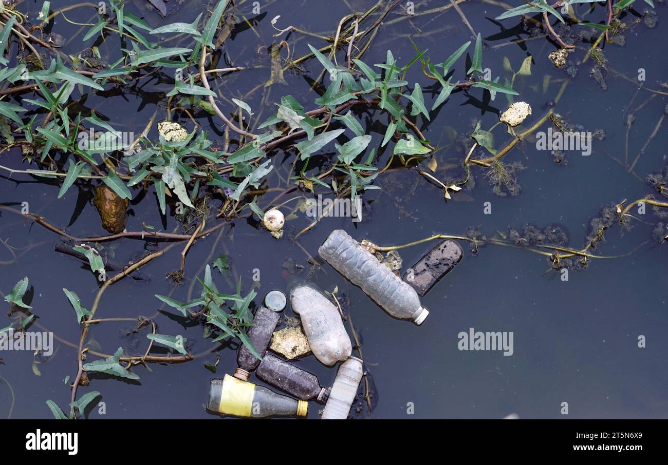A plastic waste in the river, pollution of the environment concept in ...