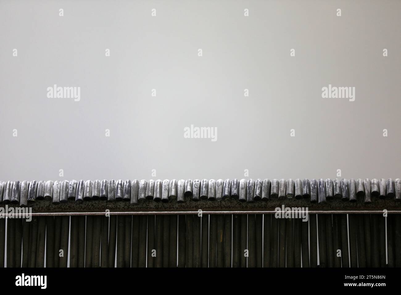 Enamel steel sheets are suspended on the production line in a factory ...