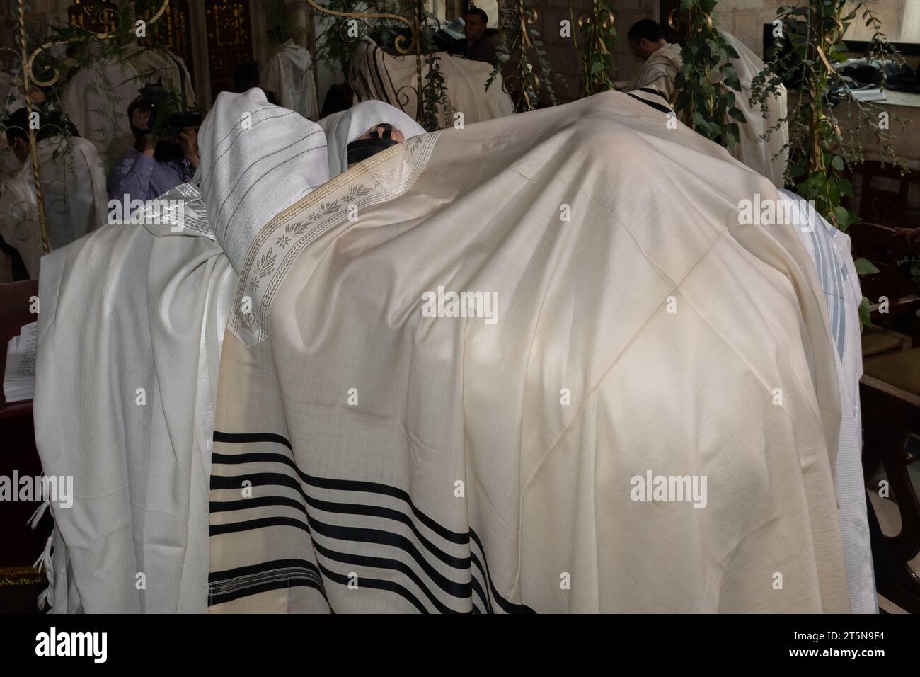 Cohanim or Jewish priests cover their heads with their prayer shawls ...