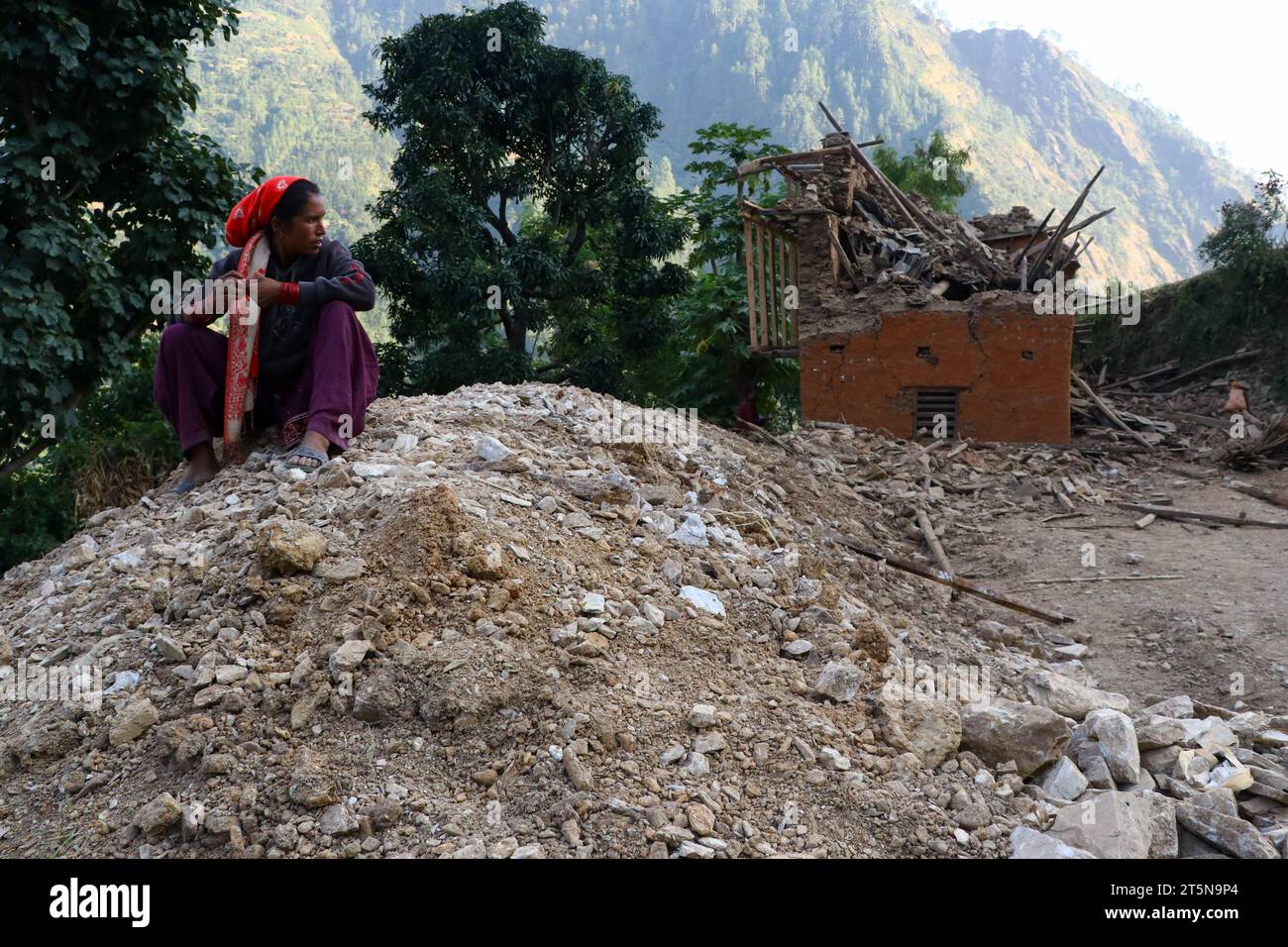 On November 5, 2023, in Jajarkot, Nepa. A woman sits outside her ...