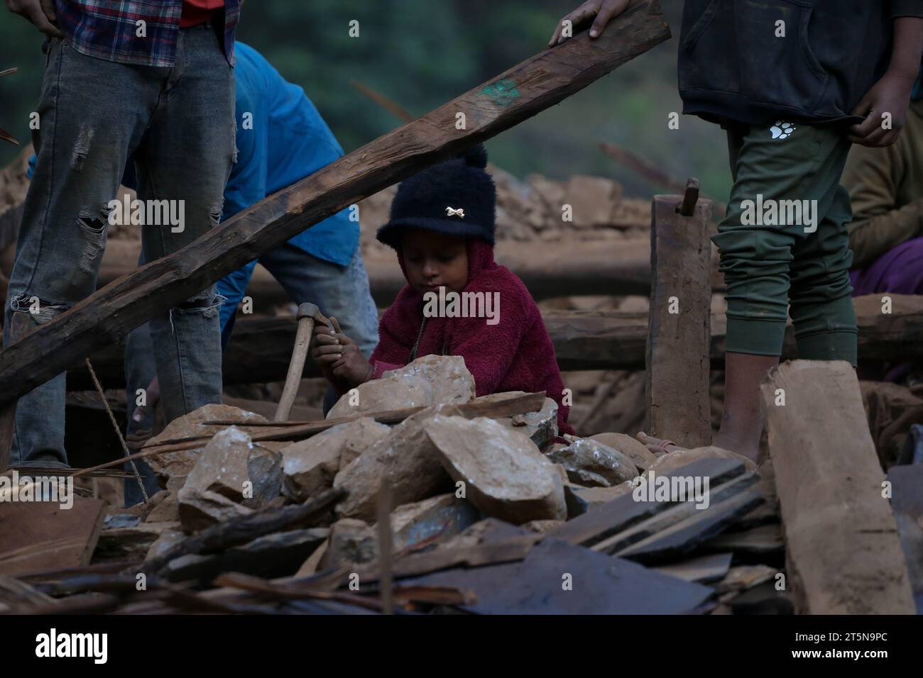 On November 5, 2023, in Jajarkot, Nepal. A child manages his collapsed ...