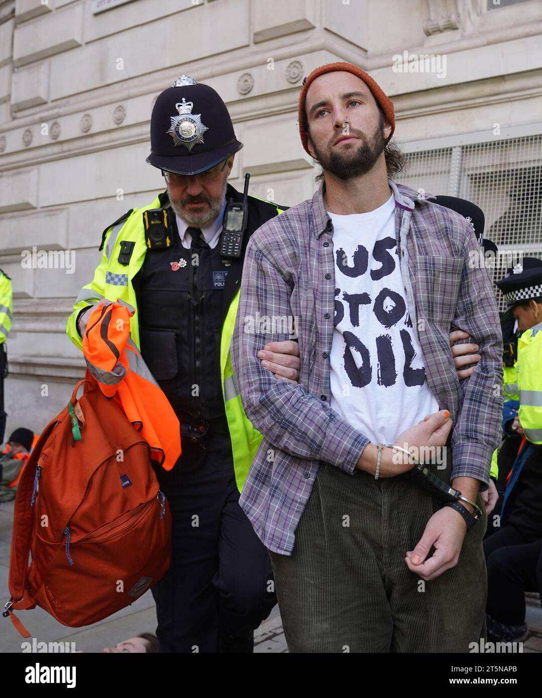 Officers from the Metropolitan Police remove a Just Stop Oil protester ...