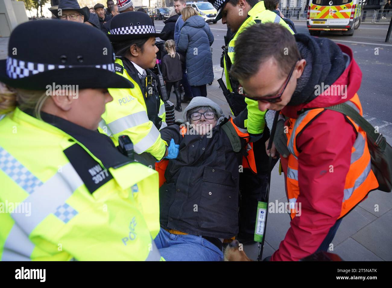 Officers from the Metropolitan Police remove a Just Stop Oil protester ...