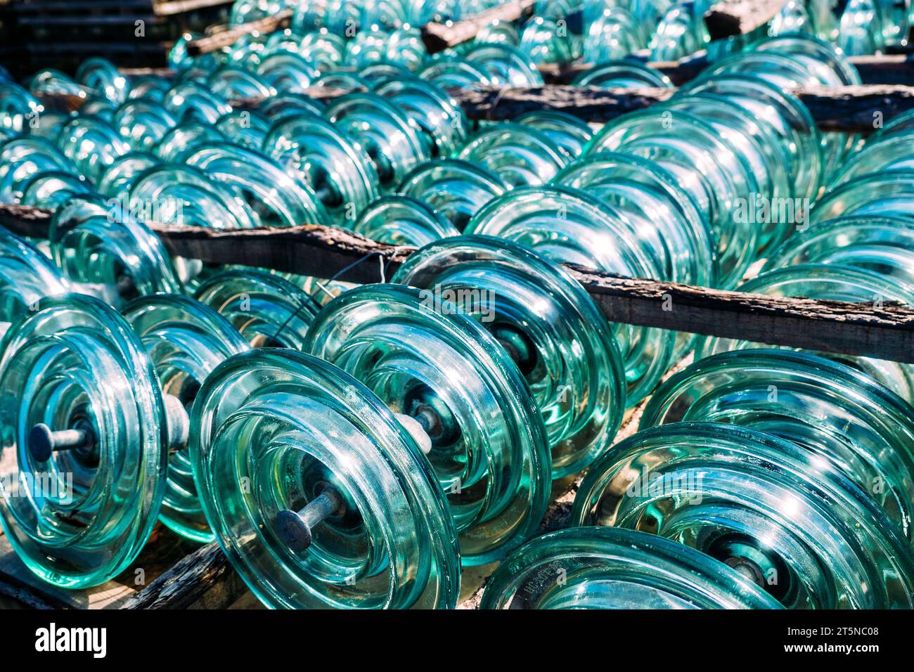 Glass transparent high-voltage insulator is in storage. Industrial ...