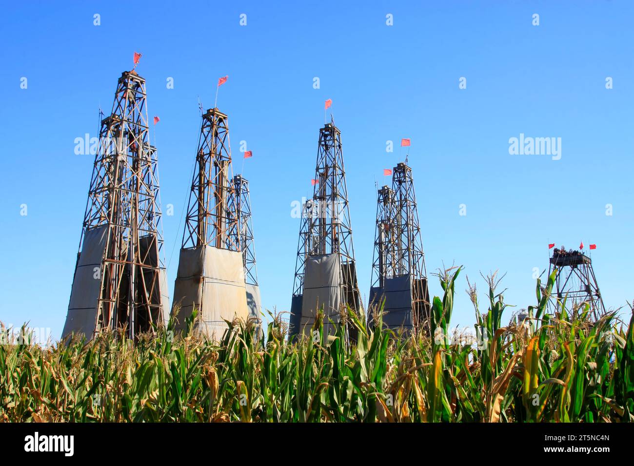 Mine derrick and crops in the blue sky background, closeup of photo ...