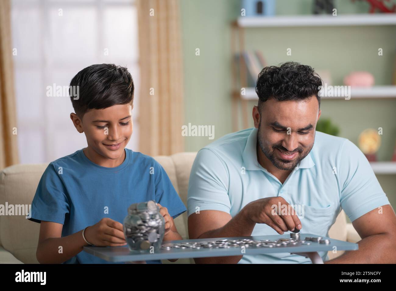 Happy indian father son counting hi-res stock photography and images ...