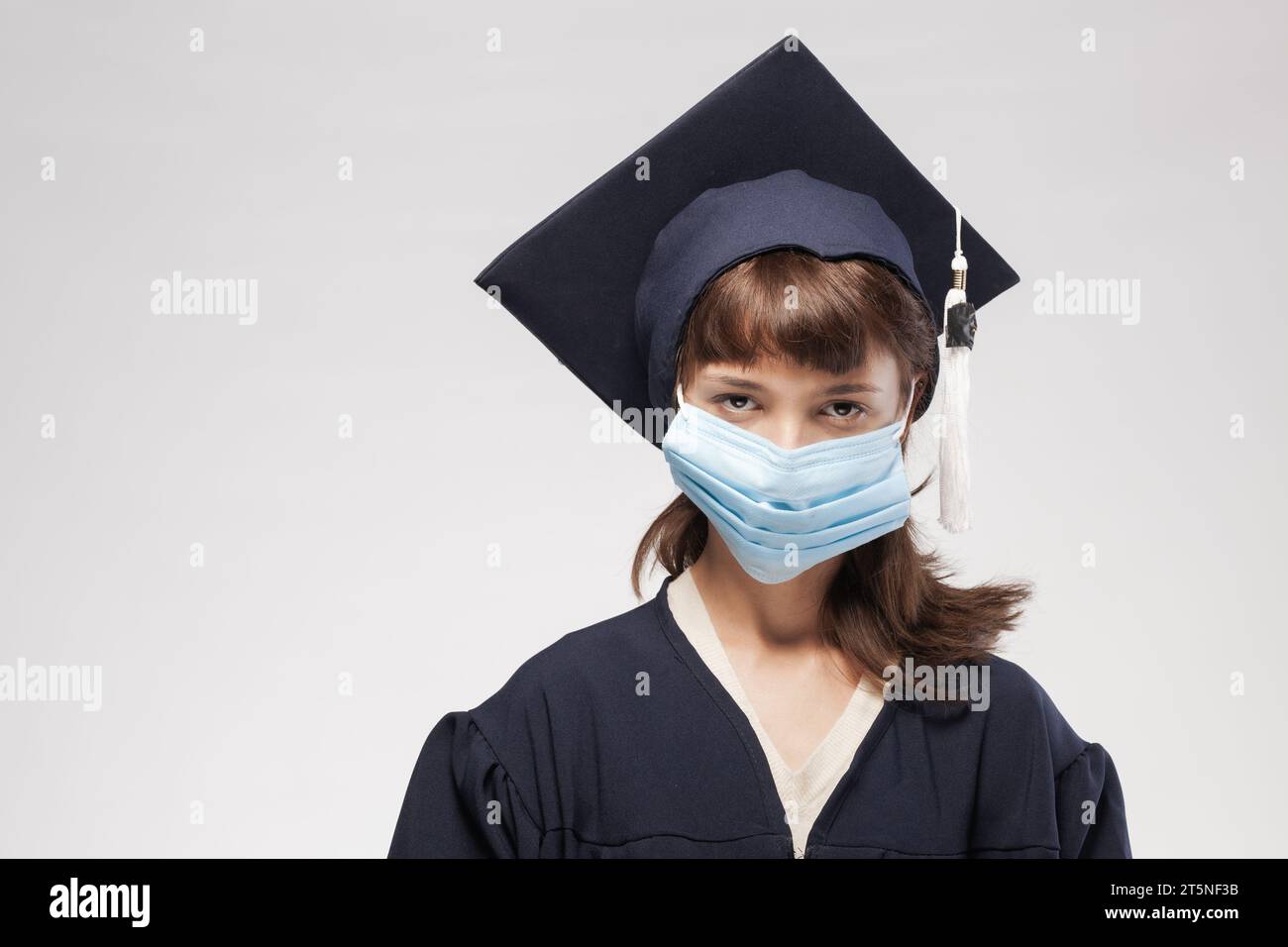 Graduation girl wearing gown and cap. Female student wearing protective ...