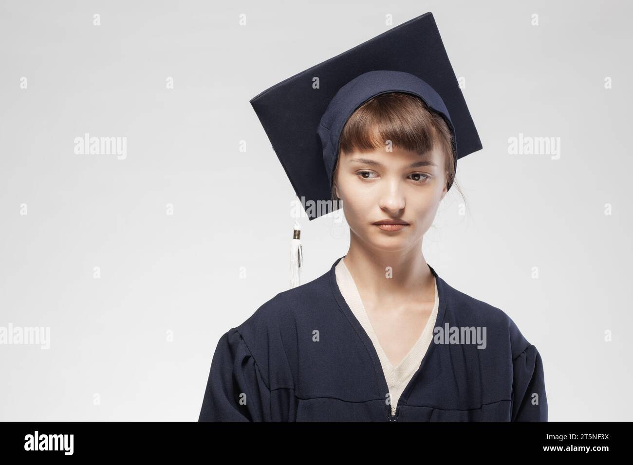 Graduation student portrait isolated on white background. Sad girl ...