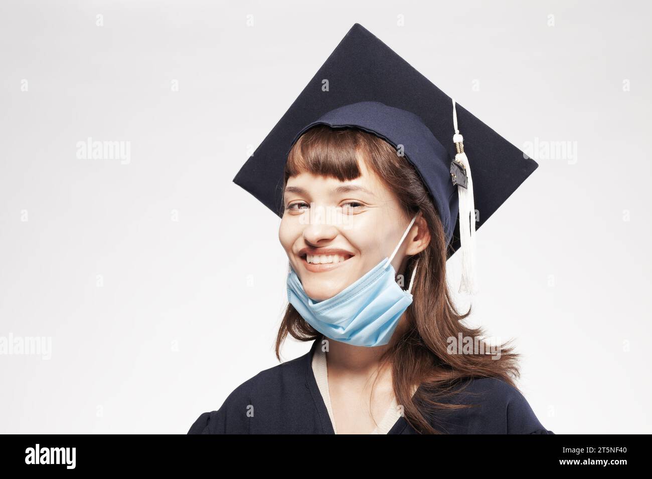 Graduation girl with gown and cap smiling. Happy female student wearing ...