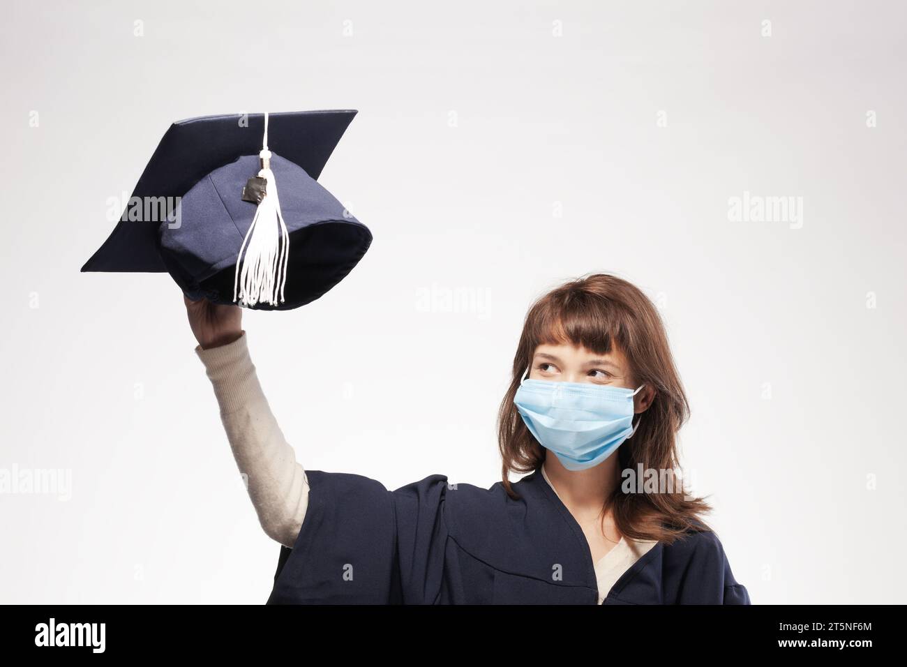 Graduation girl with gown throwing cap smiling. Happy female student ...