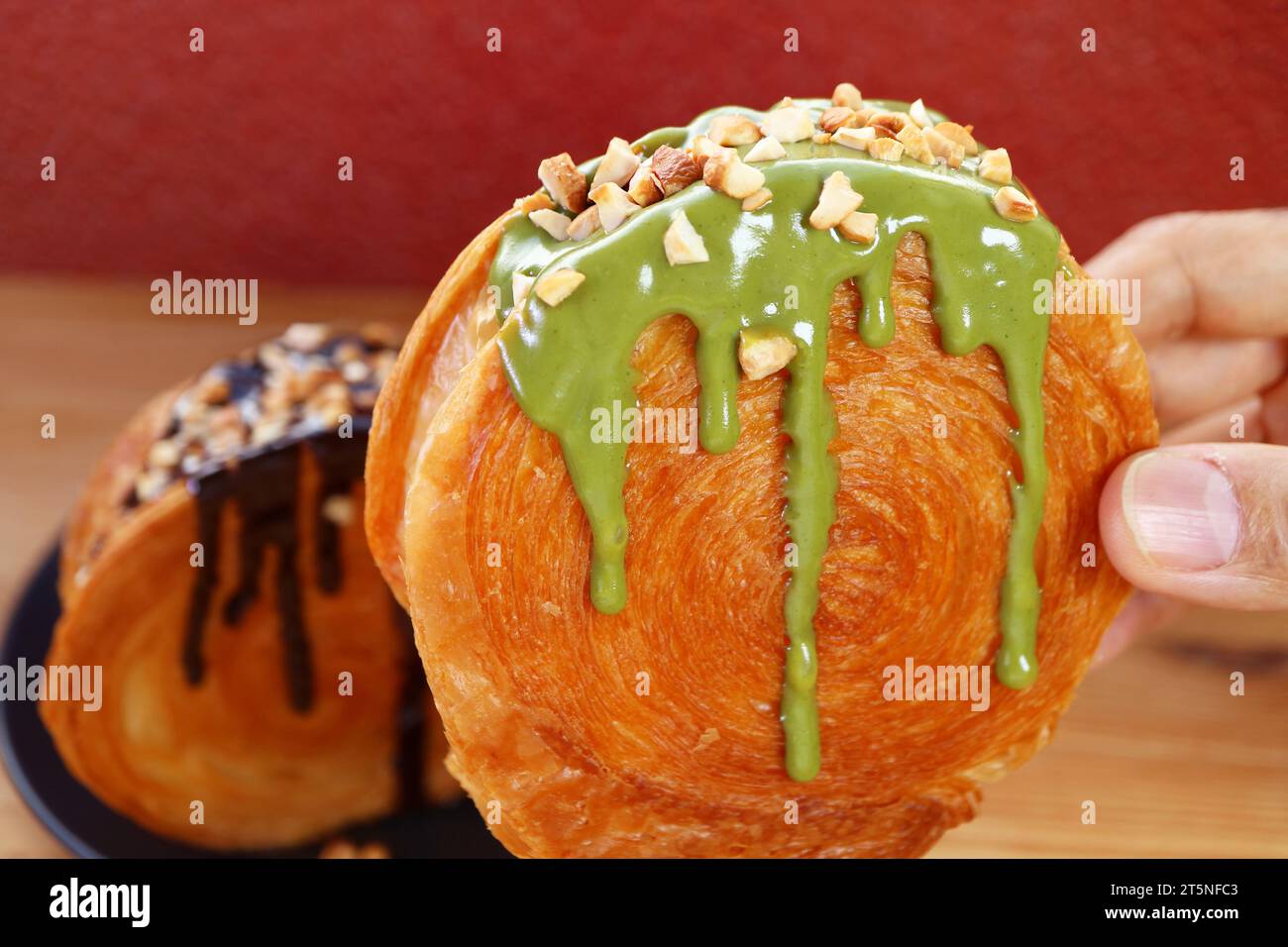 Hand Holding a Delectable Supreme Croissant with Matcha Green Tea ...