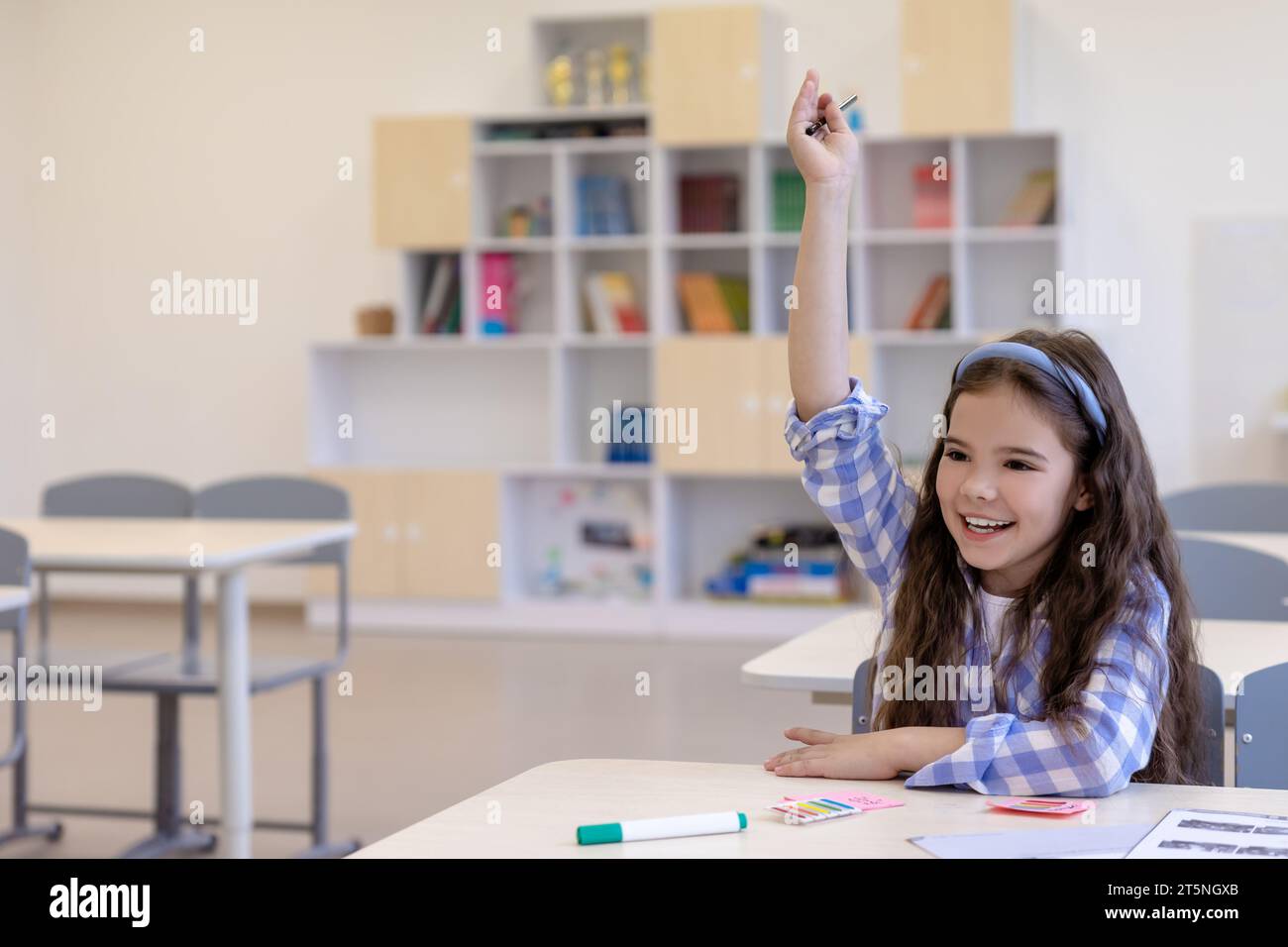 Kids raising their hand in school hi-res stock photography and images ...