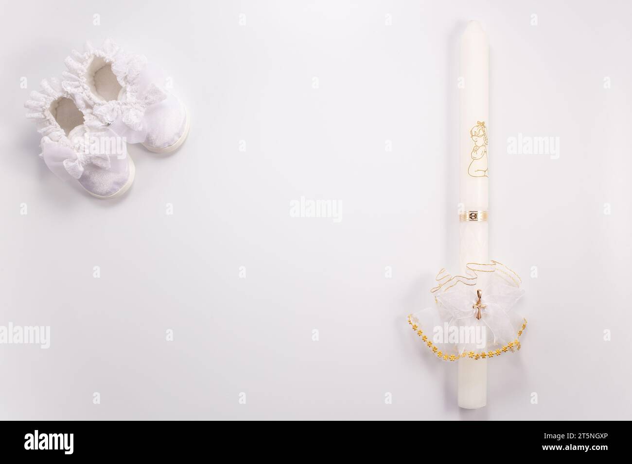 Christening background with baptism baby shoes and candle on white ...