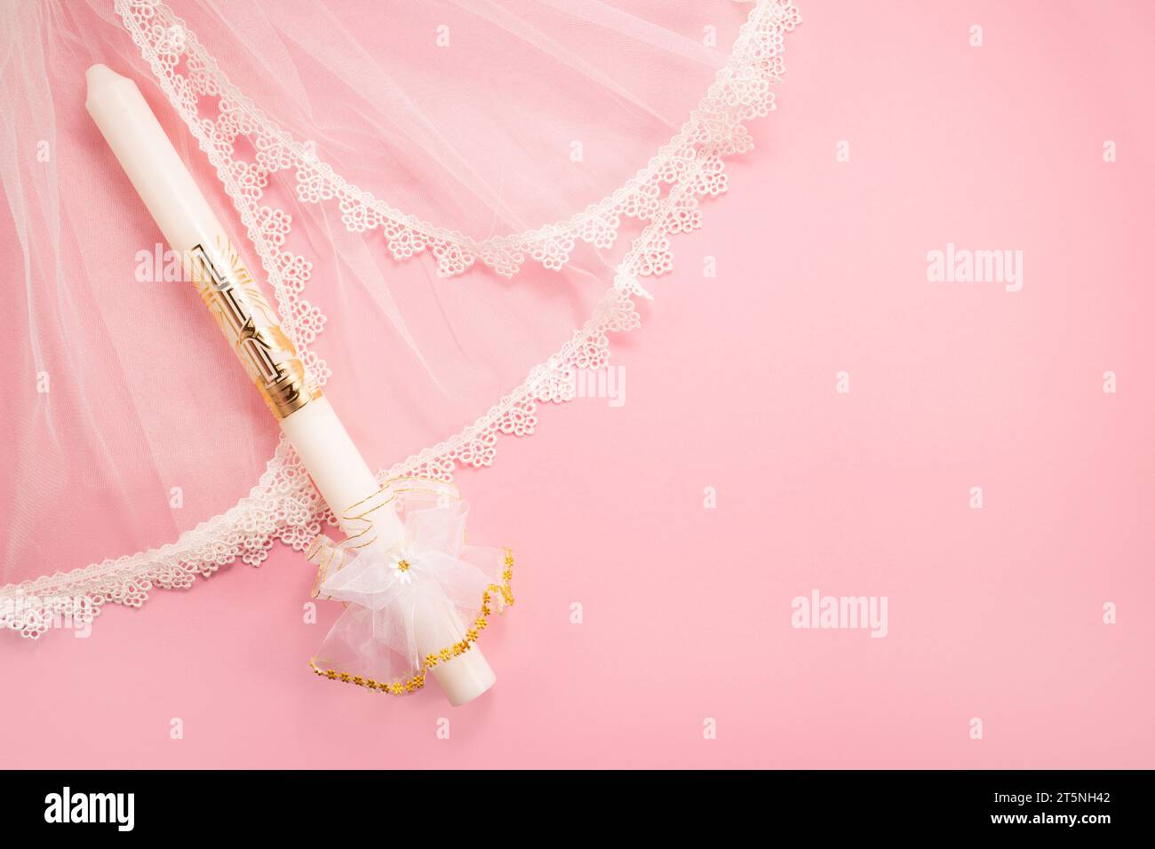 Christening background with baptism baby dress and candle on pink ...