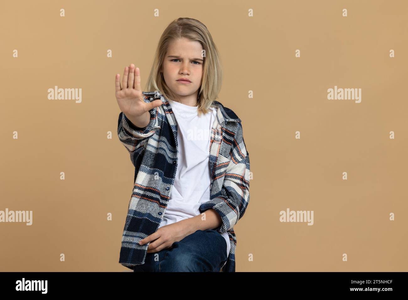 Teen girl putting hands up in a rejecting gesture Stock Photo - Alamy