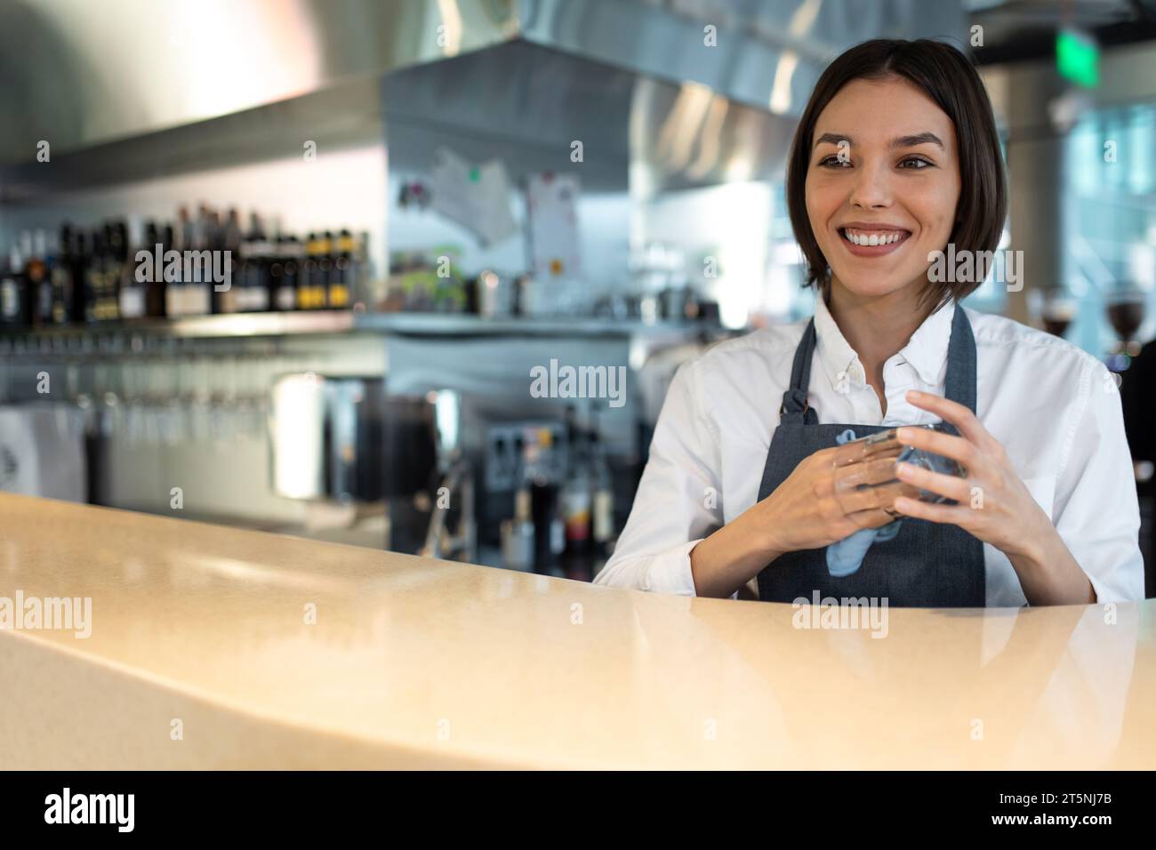 Coffee shop assistant at her working place looking contented and ...