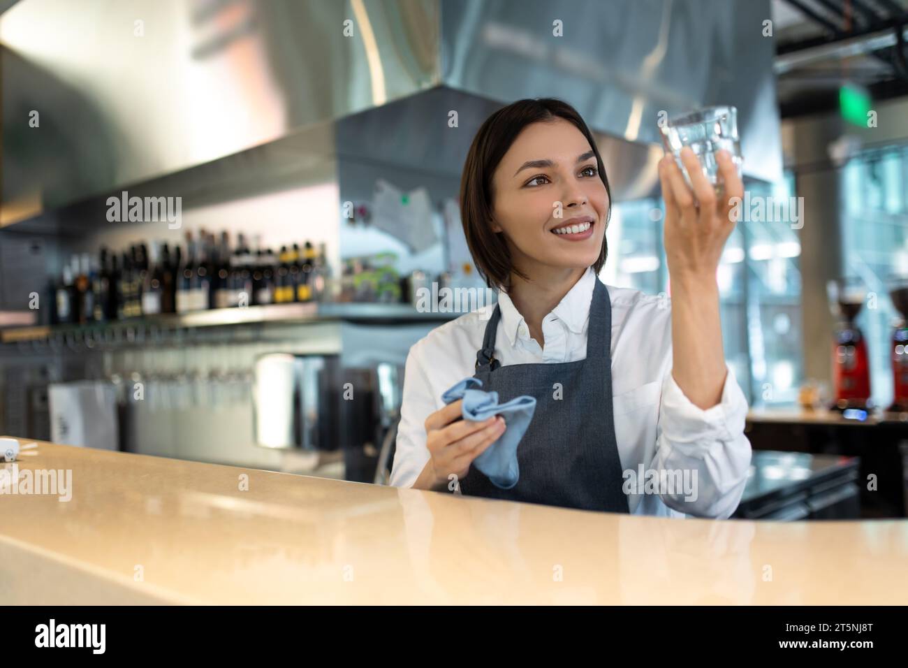 Coffee shop assistant at her working place looking contented and ...