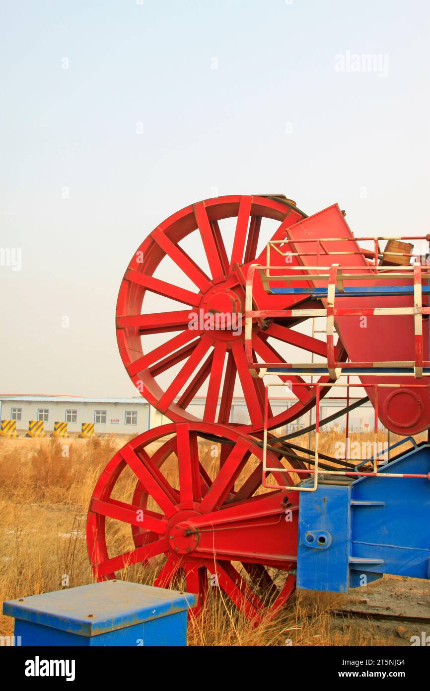 Tower type pumping unit wheel parts in the bushes, closeup of photo ...