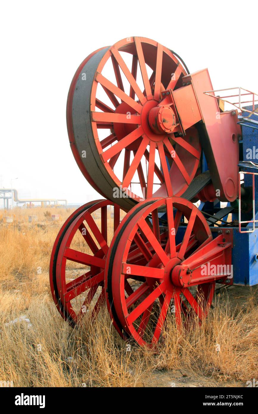 Tower type pumping unit wheel parts in the bushes, closeup of photo ...