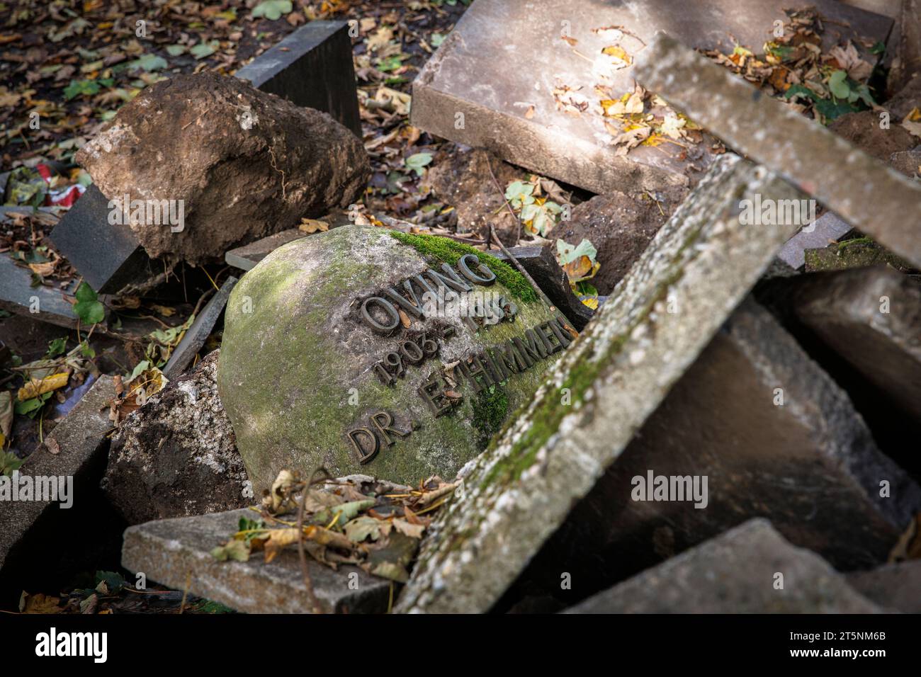 old gravestones from dissolved graves lie on a heap for disposal behind ...